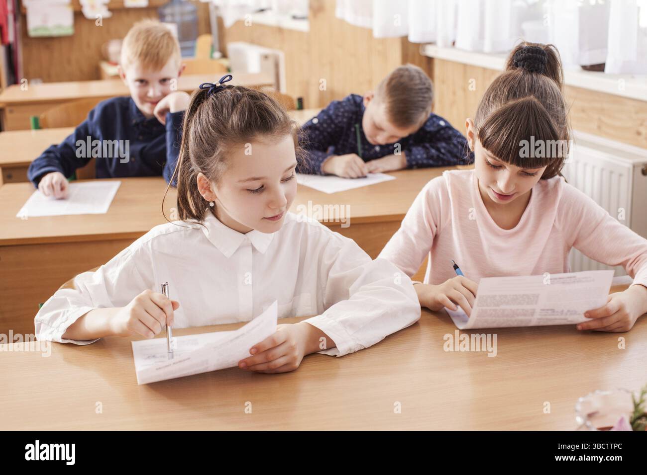 Children of primary school taking an exam writing school test Stock ...