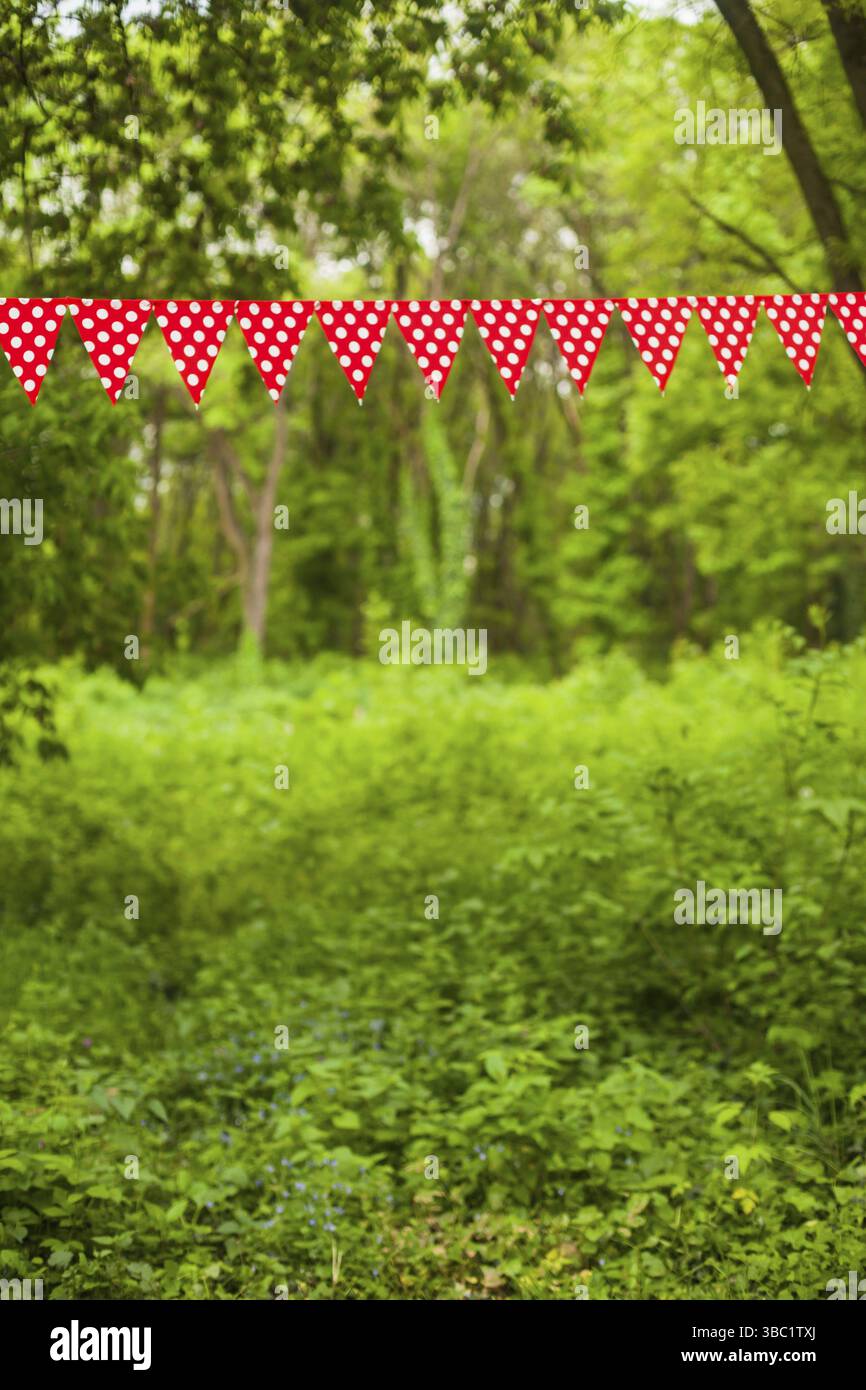 Red triangular flags with white dots on the nature background Stock ...