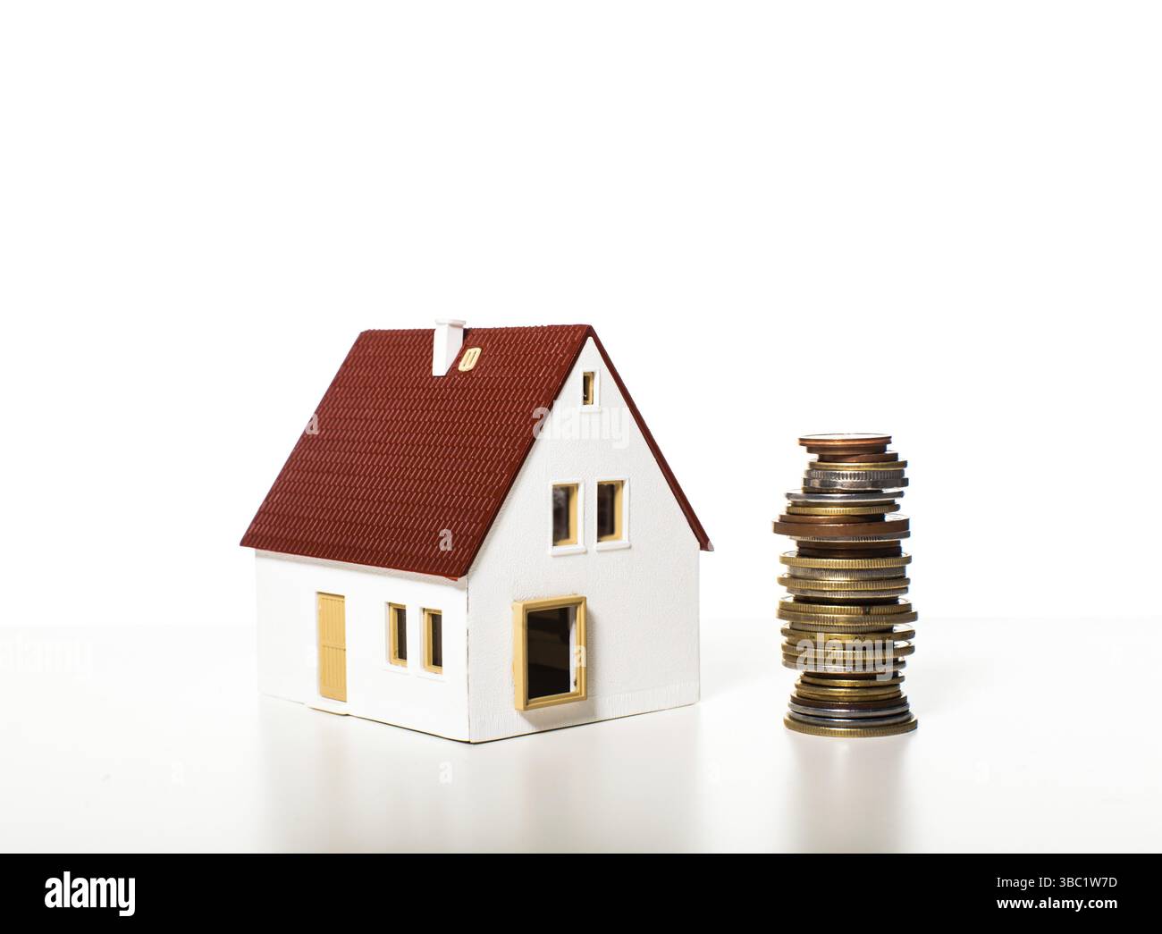 Money house from the coins on the white background. Concept for utility ...