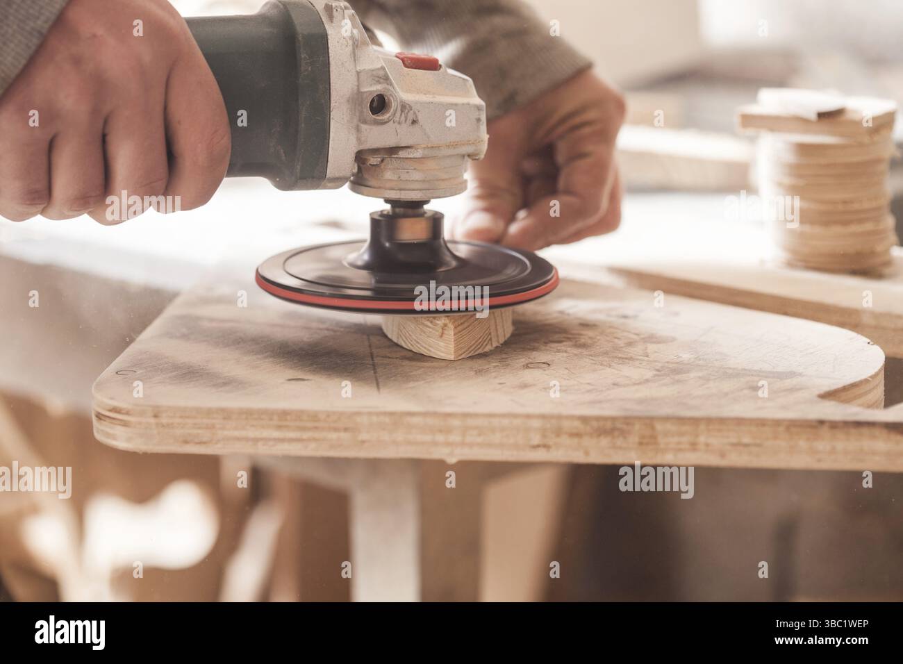 Worker polishing wood table where carpenter hands sanding a wood with ...