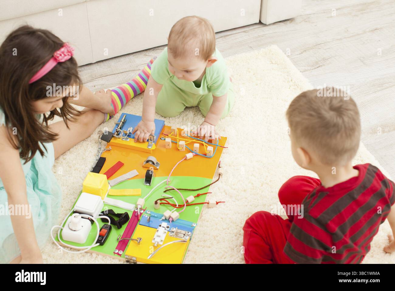 Handmade DIY busy board - sensory children's toy Stock Photo - Alamy