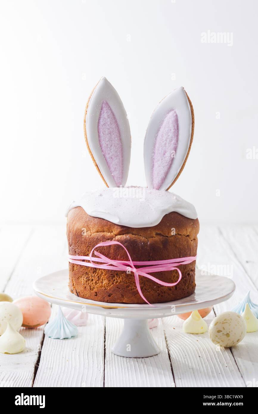 The beautiful Easter cake with bunny ears. The cake covered with white ...