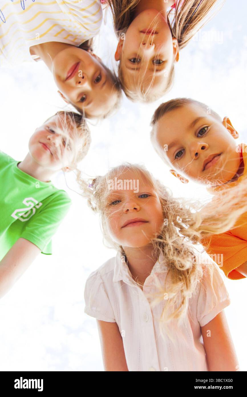 Five adorable smiling kids faces in circle, light portrait on a white ...