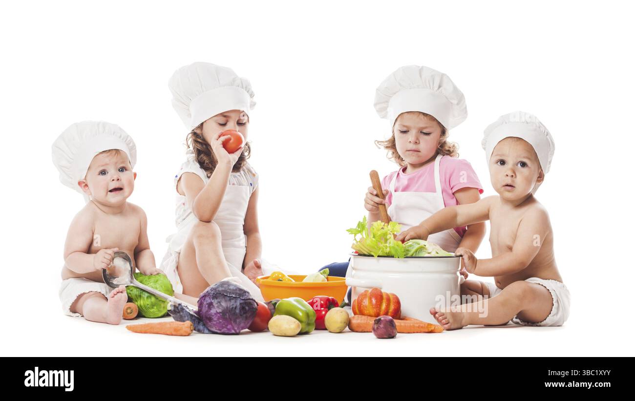 Group of kids play and cook with vegetables. Little chefs isolated on ...