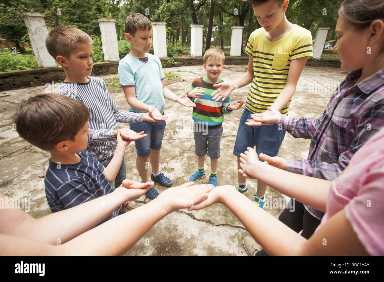 Children playing the game outdoors clapping hands in a circle Stock ...