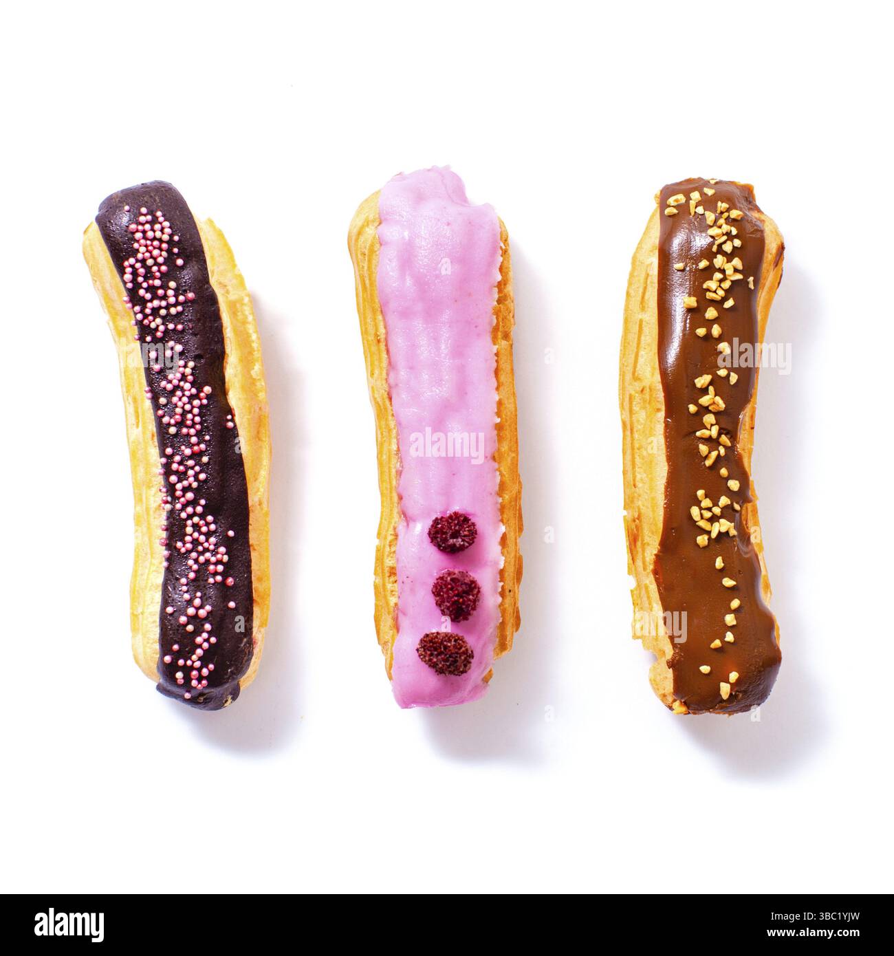 Top view of a set of three eclairs with different fillings and design ...