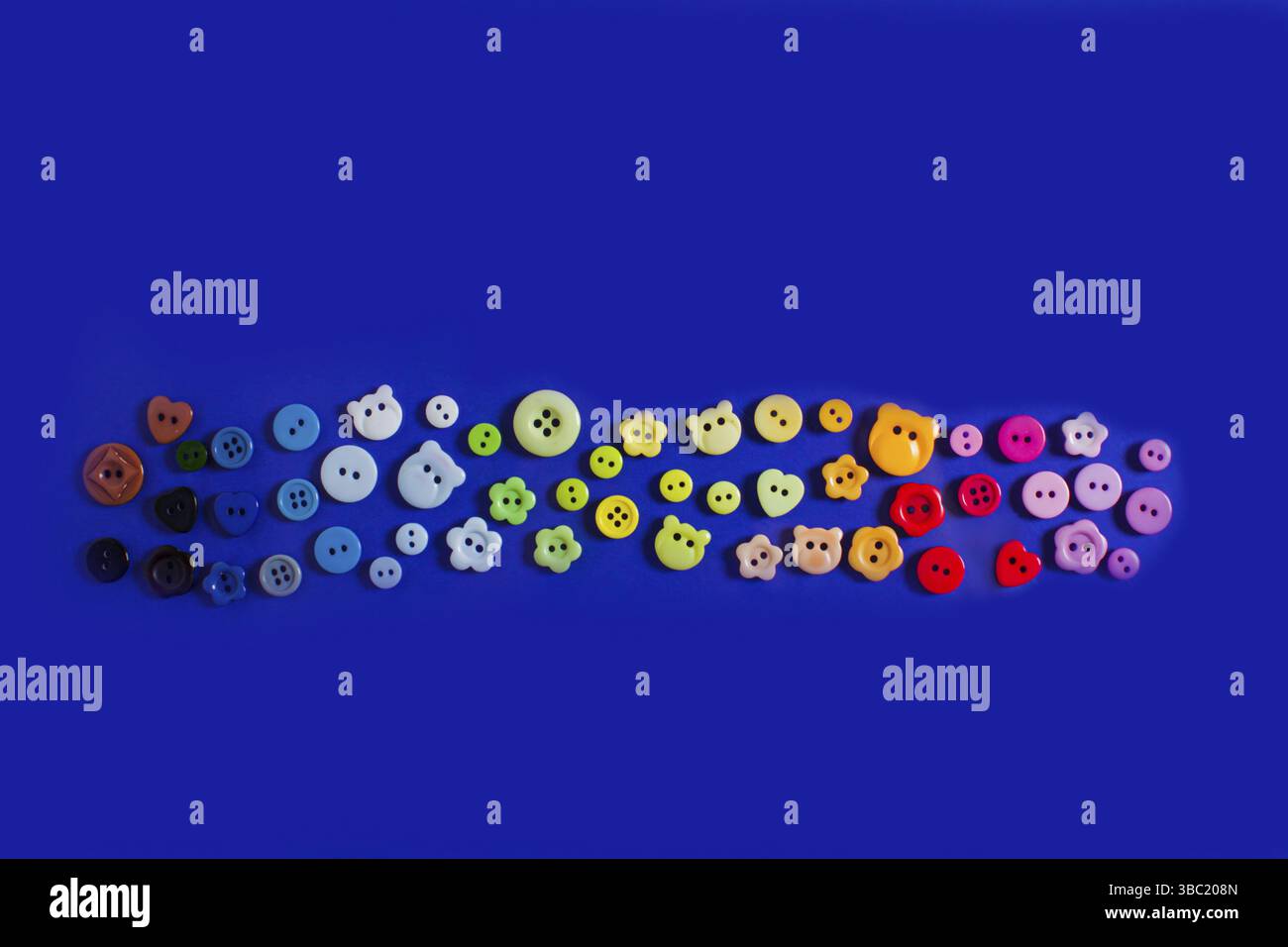 Top view flat-lay variety of buttons in different shapes, sizes and ...