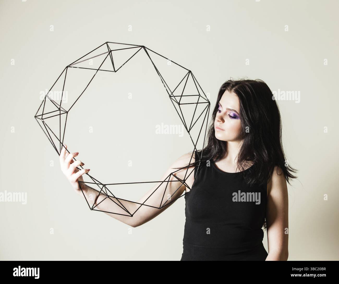 Fashion girl is posing with art geometry object Stock Photo - Alamy