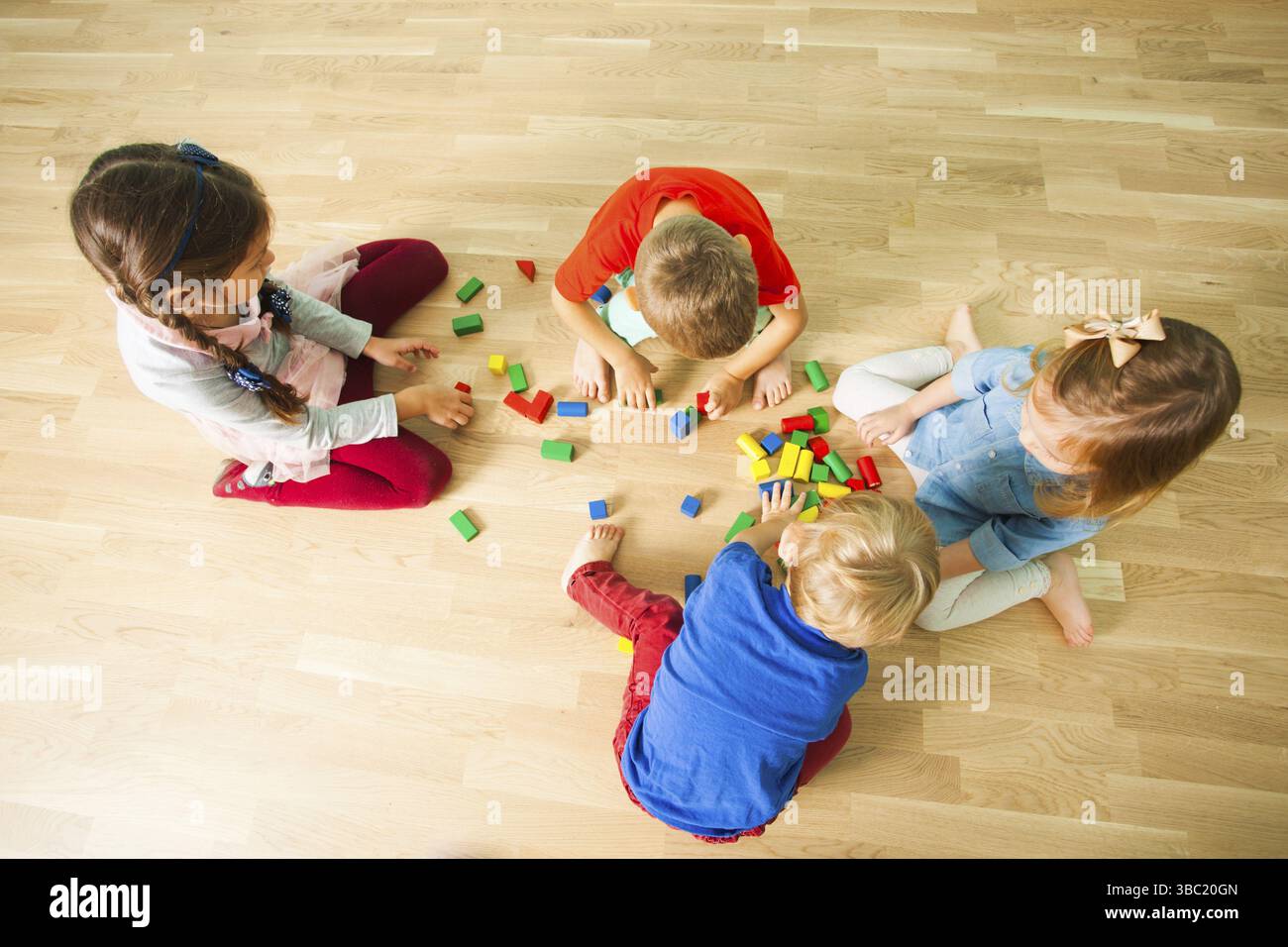 Happy kids in kindergarten spending time playing without adults ...