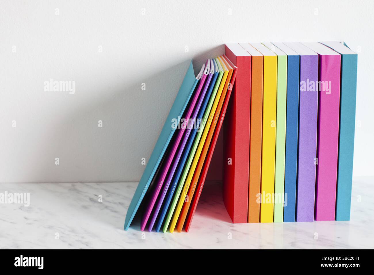 Colorful books are outlined in the colors of the rainbow. Stacked of ...