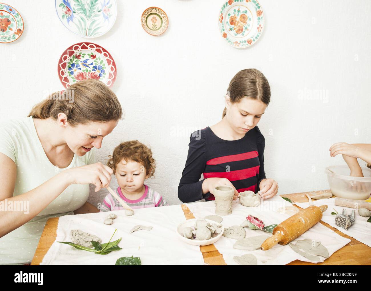 Process modeling figures from white clay, girls are making arts at the ...
