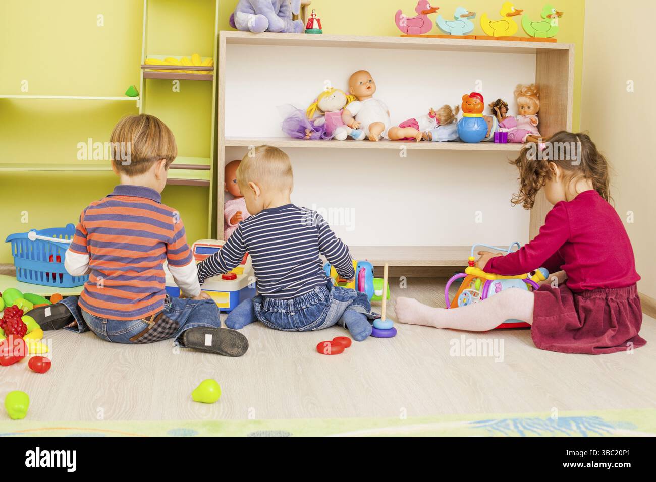 Two little boys are playing in the role of cashier and buyer in the ...