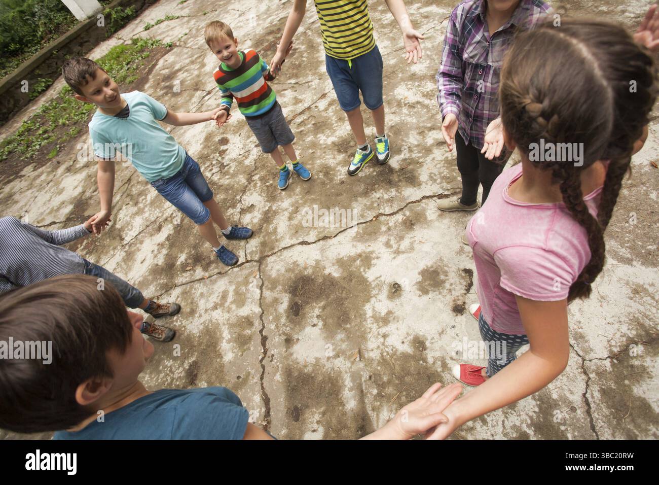 Children playing the game outdoors clapping hands in a circle Stock ...