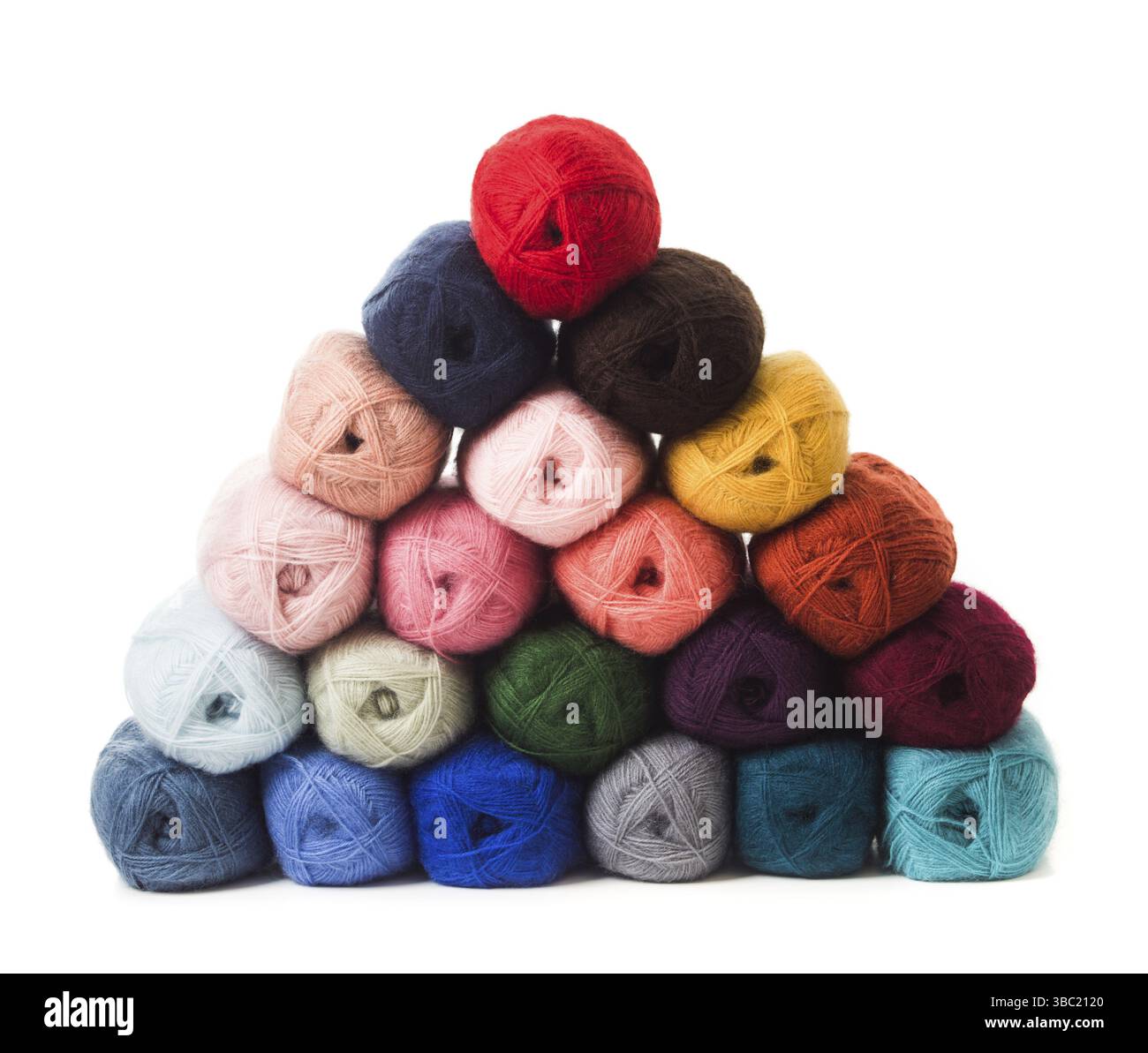 The collection of multicolored threads that are stacked on top of each ...