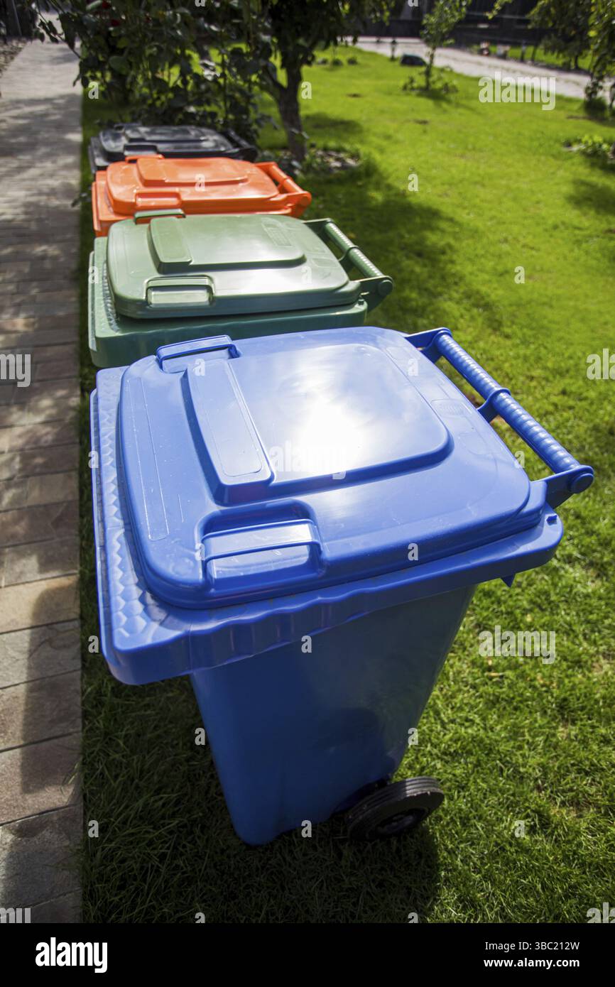 Side view new plastic trash bins of different colours for different ...