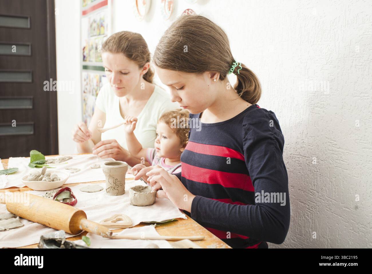 Process modeling figures from white clay, girls are making arts at the ...