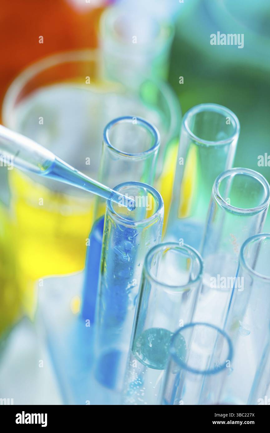 The blue drop from pipette over laboratory tubes Stock Photo - Alamy