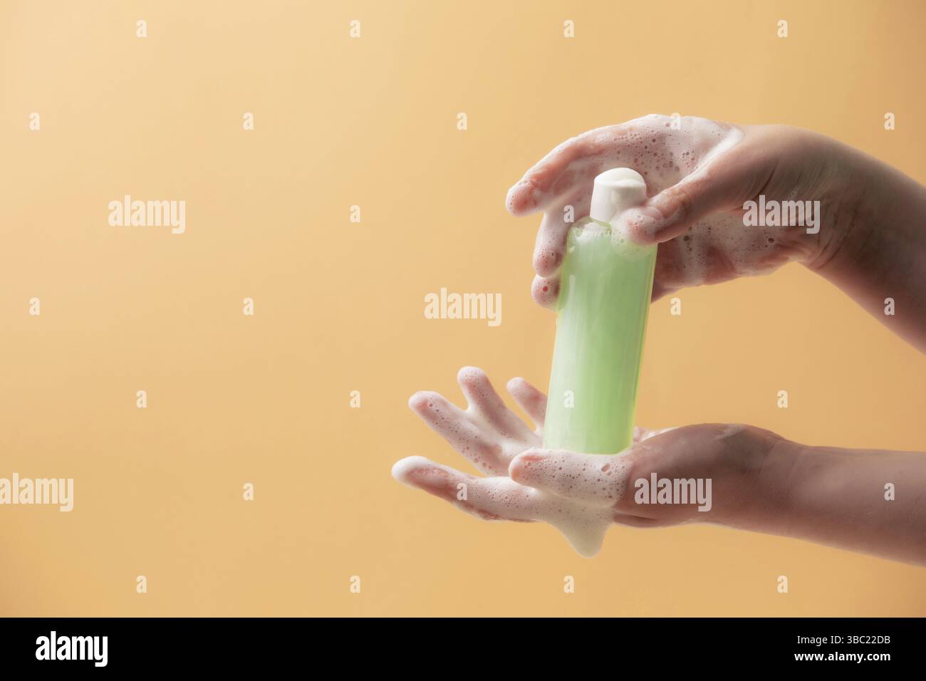 Natural shampoo in the bottle at the female hands with foam. Natural ...