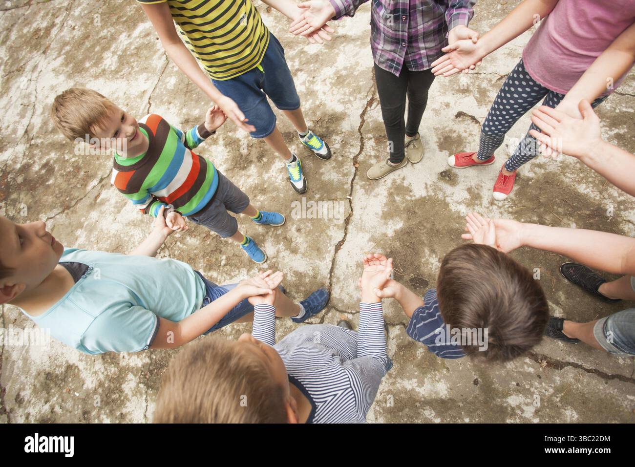 Children playing the game outdoors clapping hands in a circle Stock ...