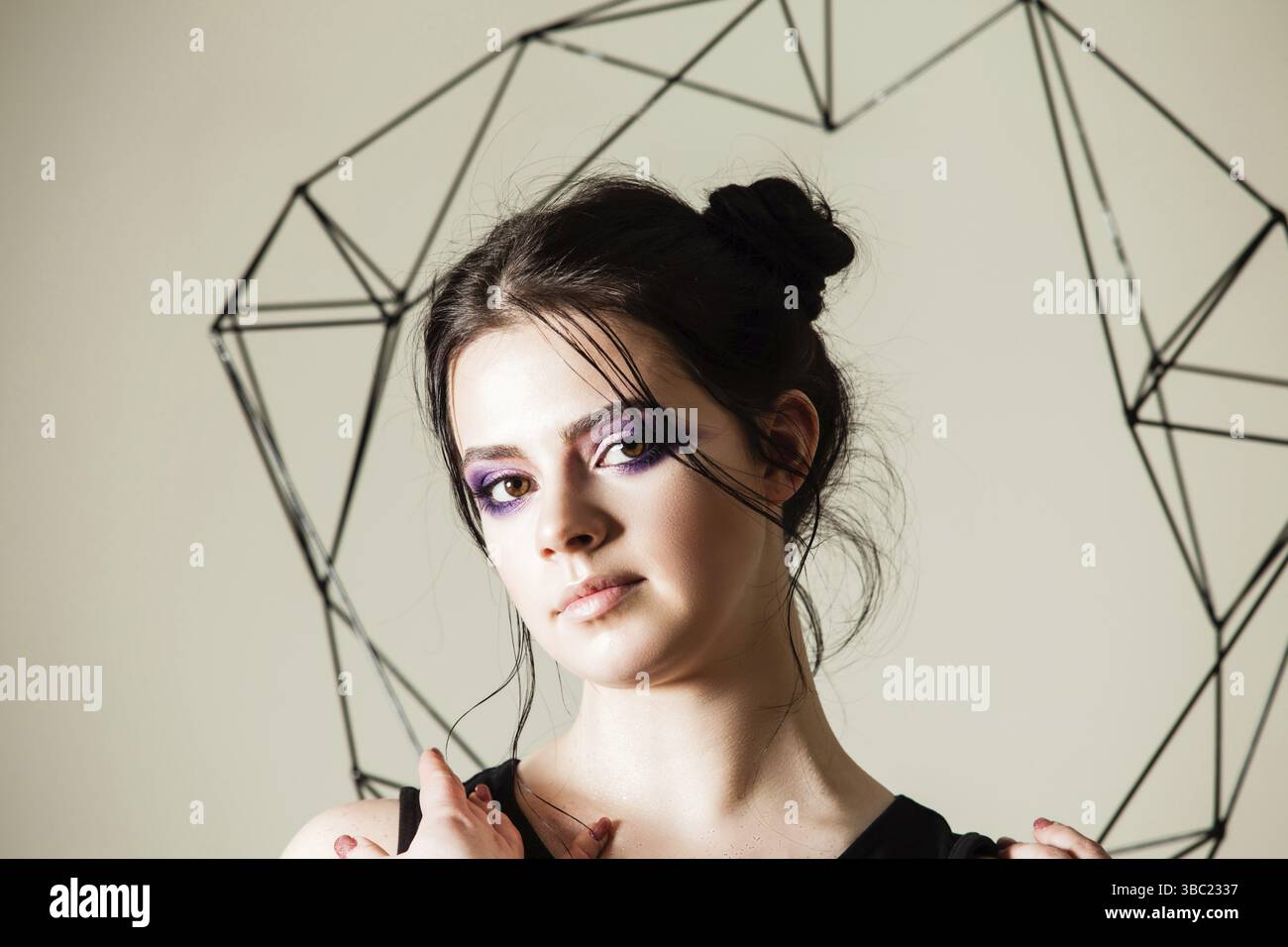 Fashion girl is posing with art geometry object, playful kitty face ...