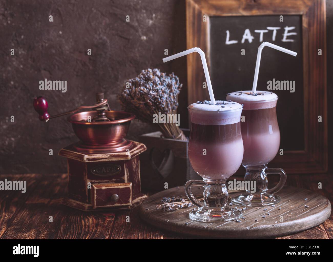 Hot latte in the big double wall glasses with lavender grains in the ...