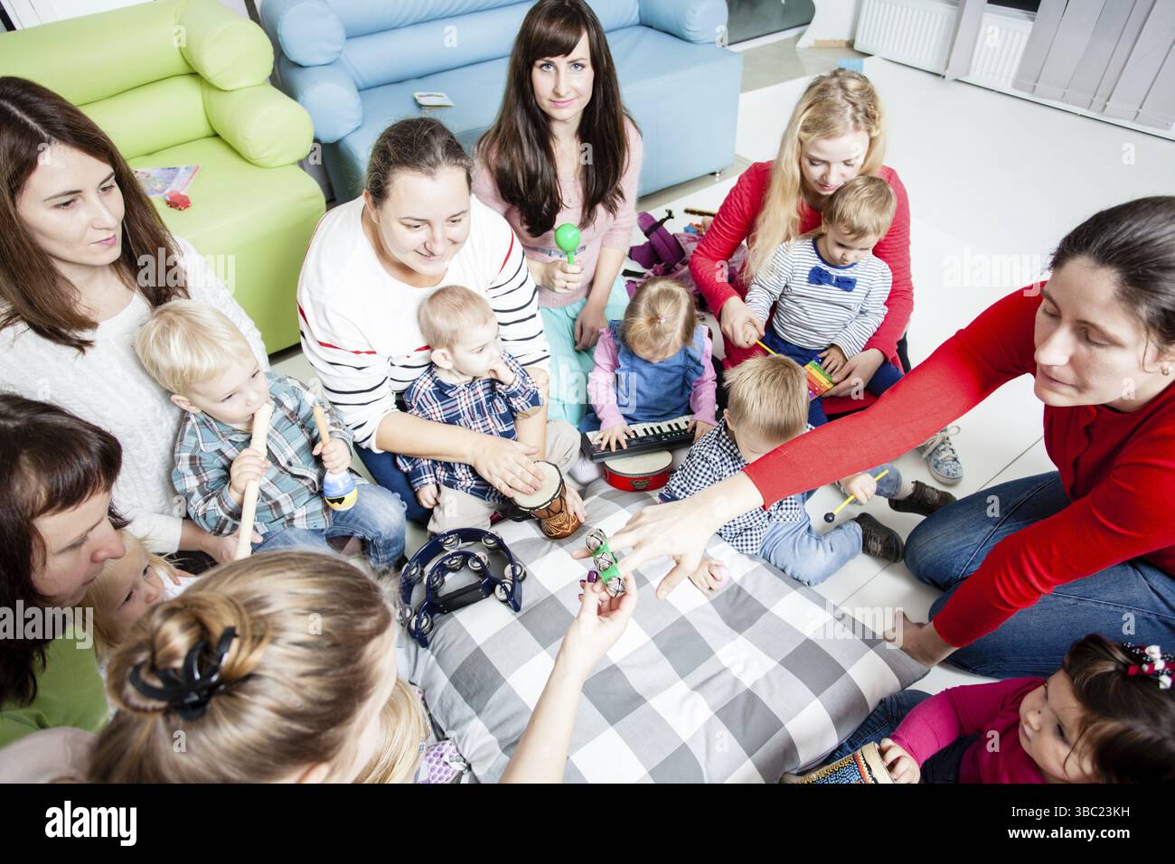 Moms with children at the music lesson in the kindergarten ...