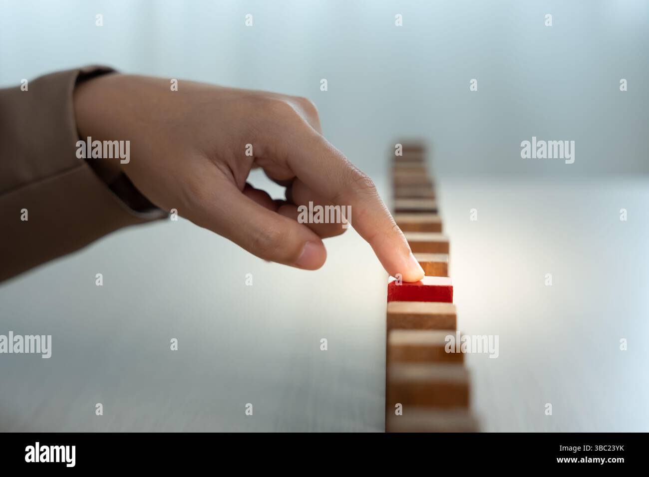 insurance with hands protect domino. Businessman hands stop dominoes ...