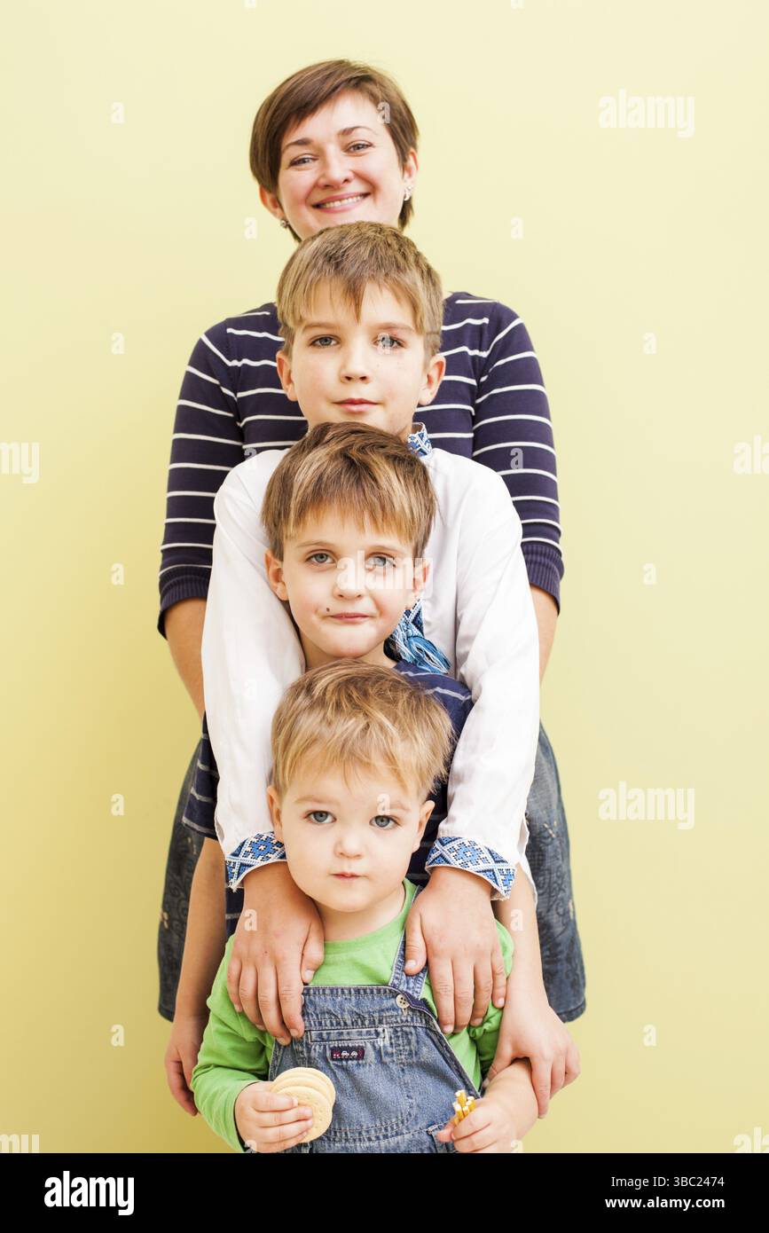 Mother with her three sons in the room. Family portrait Stock Photo - Alamy