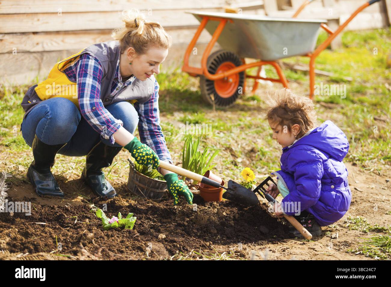 Portrait Of Adorable Pair Of Mother And Daughter Working In The Back