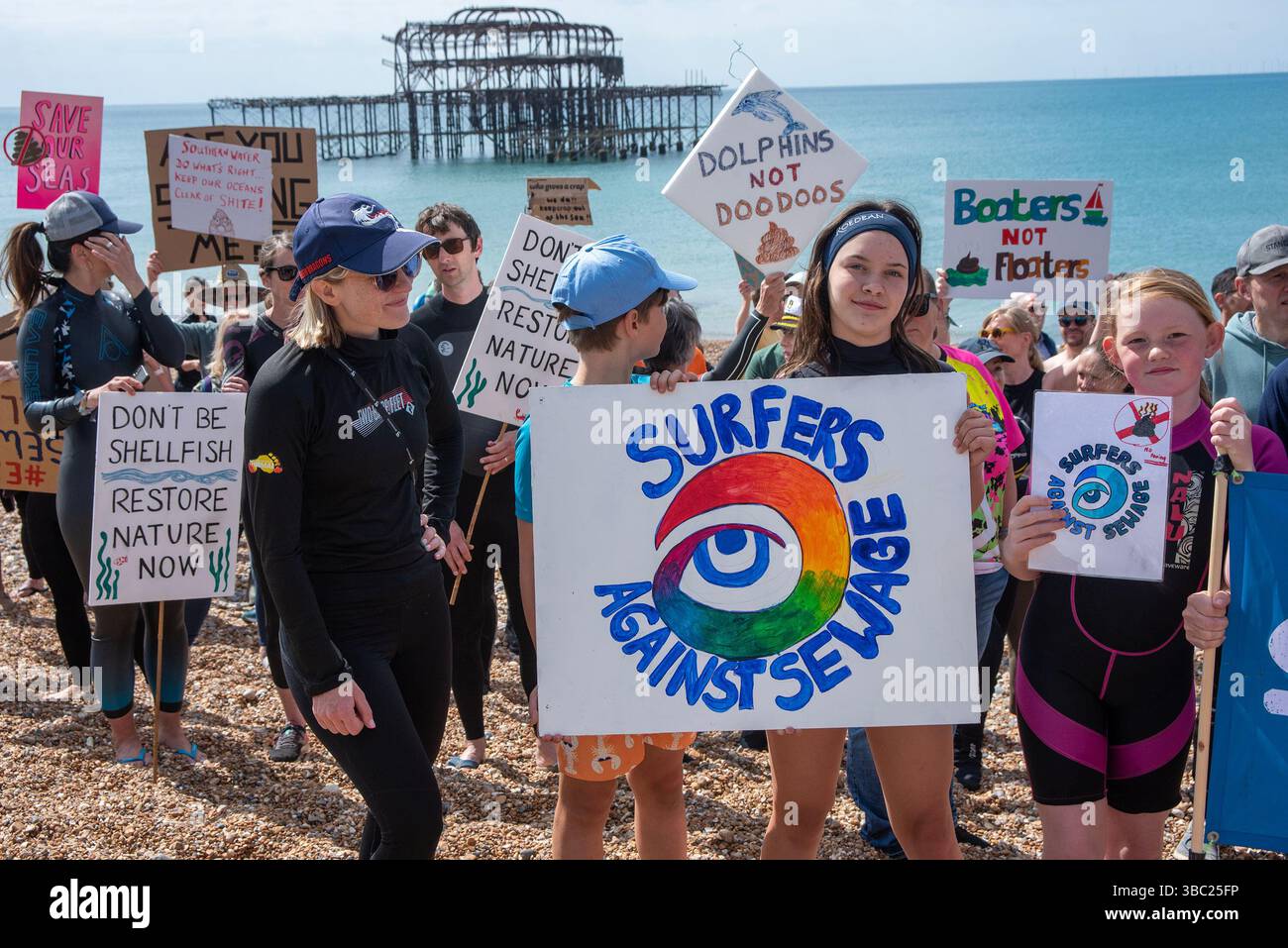 Brighton, UK. 17th May, 2025. Protesters hold placards expressing their ...