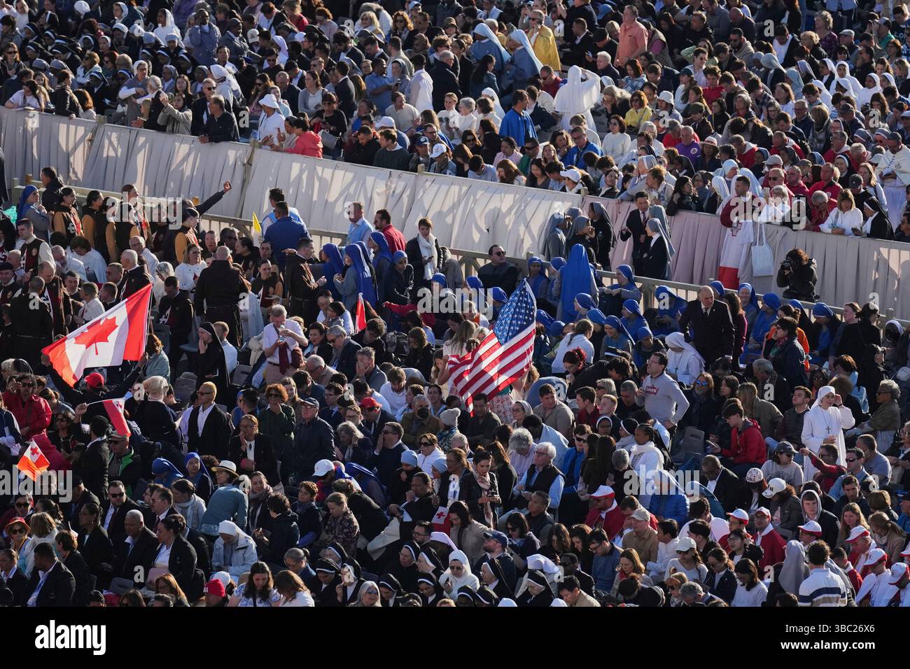 The Canadian and U.S. flag are waved as people gather in St. Peter's ...