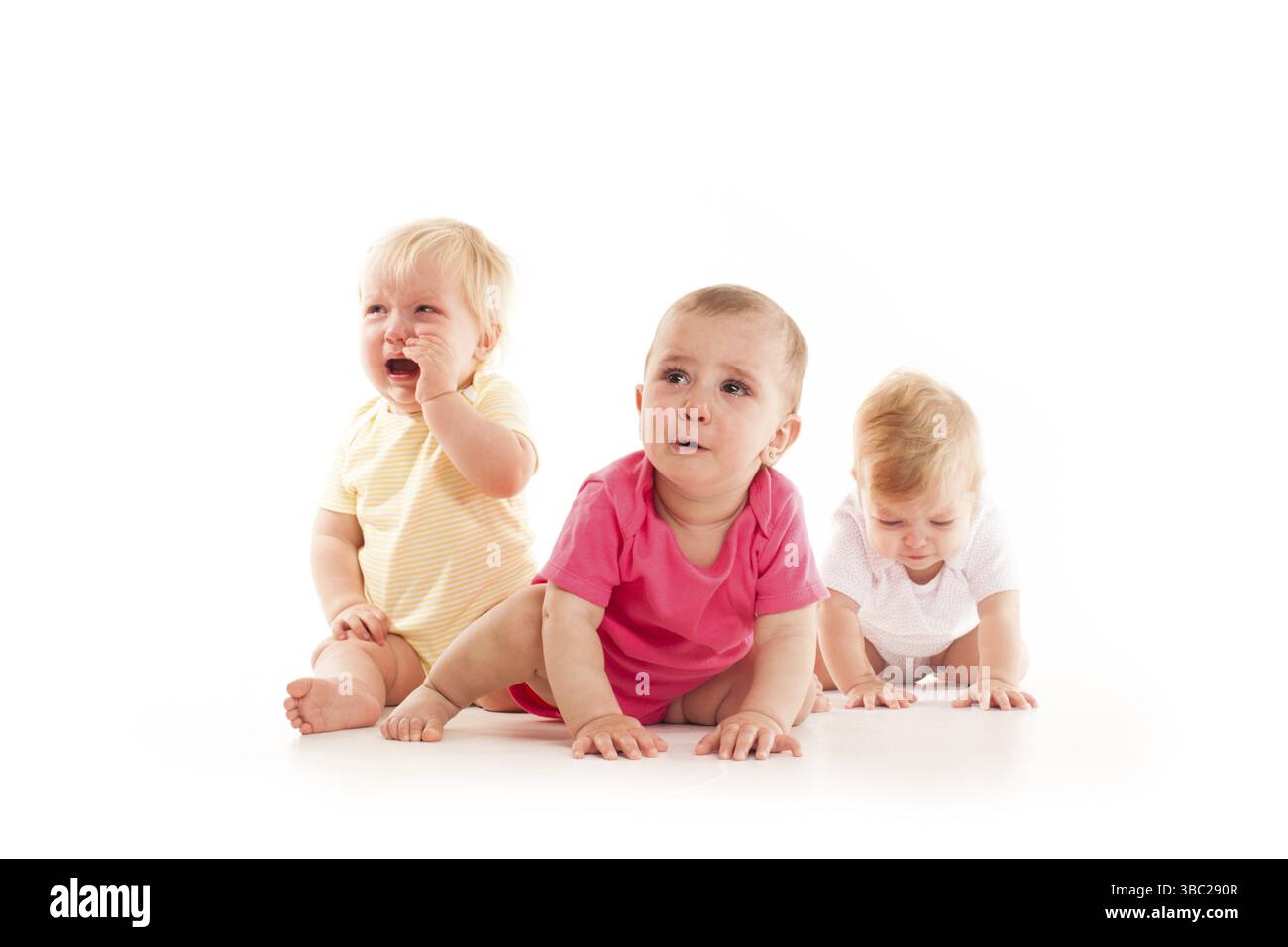 Three crying blondes babies, sitting isolated on white Stock Photo - Alamy