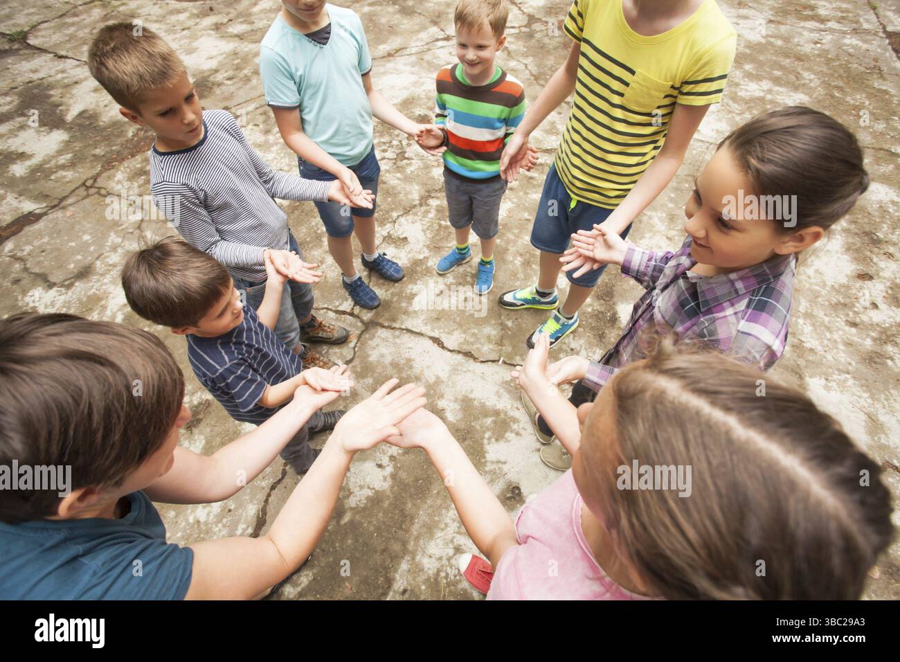 Children playing the game outdoors clapping hands in a circle Stock ...