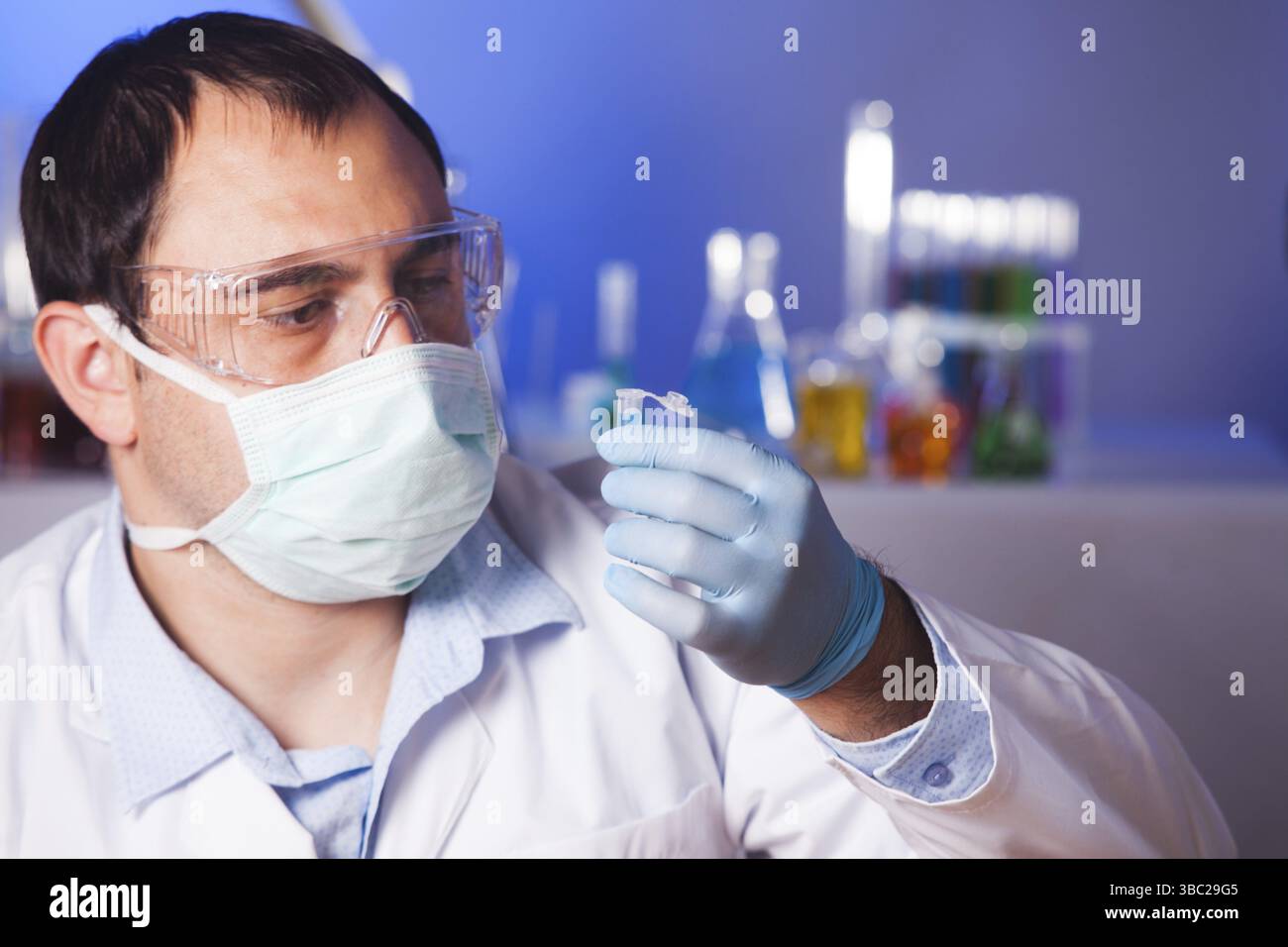 Scientist is thinking about research and hold eppendorf tube Stock Photo - Alamy