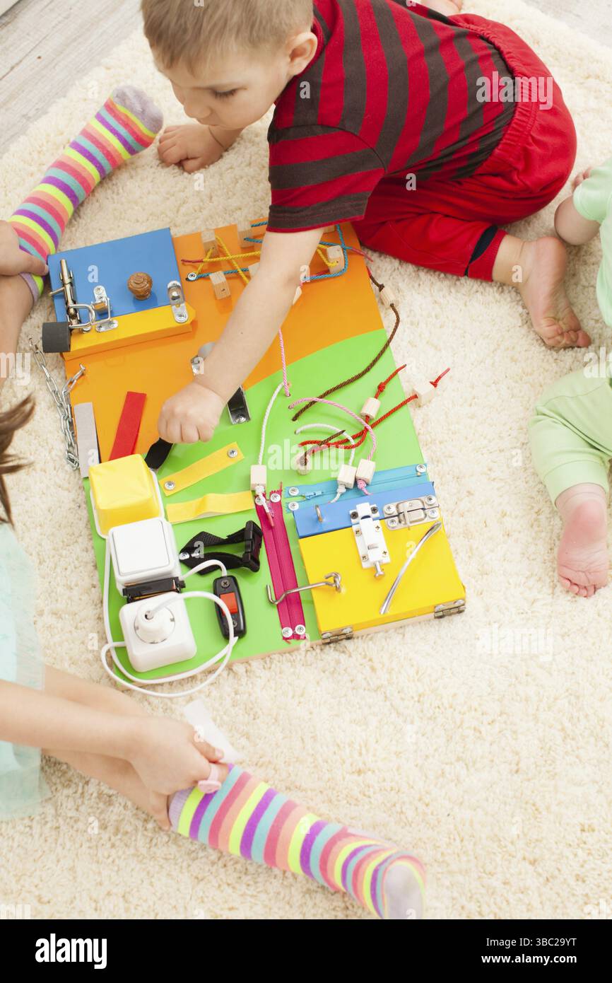 Handmade DIY busy board - sensory children's toy Stock Photo - Alamy