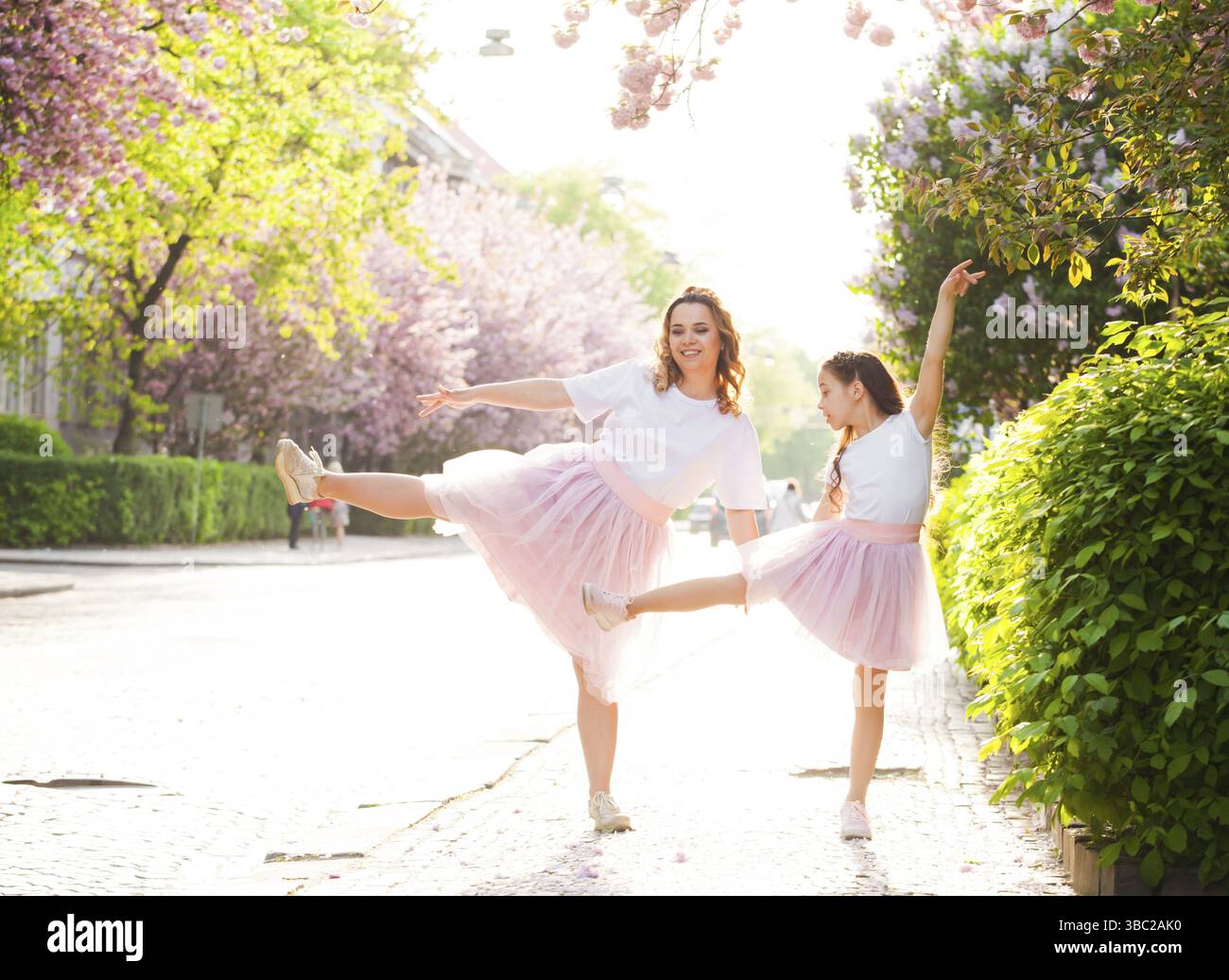 Happy mother's day. Child daughter show mom how to dance. Mum and girl ...