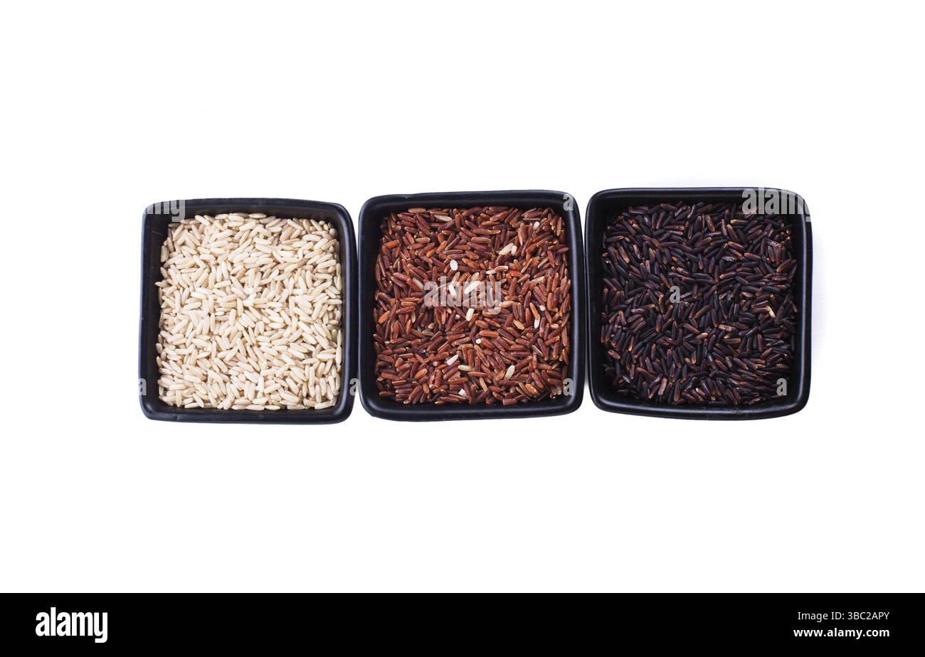 Various types of non-white rice in black bowls isolated on white Stock ...