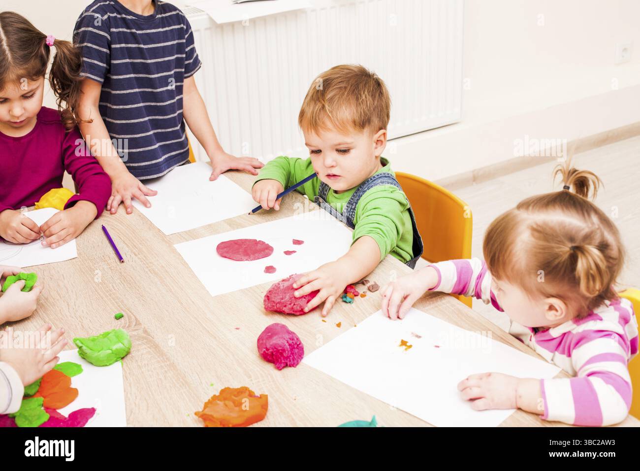 The children is making a figures plasticine on the table, kindergarten ...