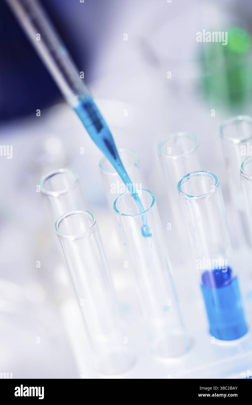 The blue drop from pipette in laboratory tubes Stock Photo - Alamy