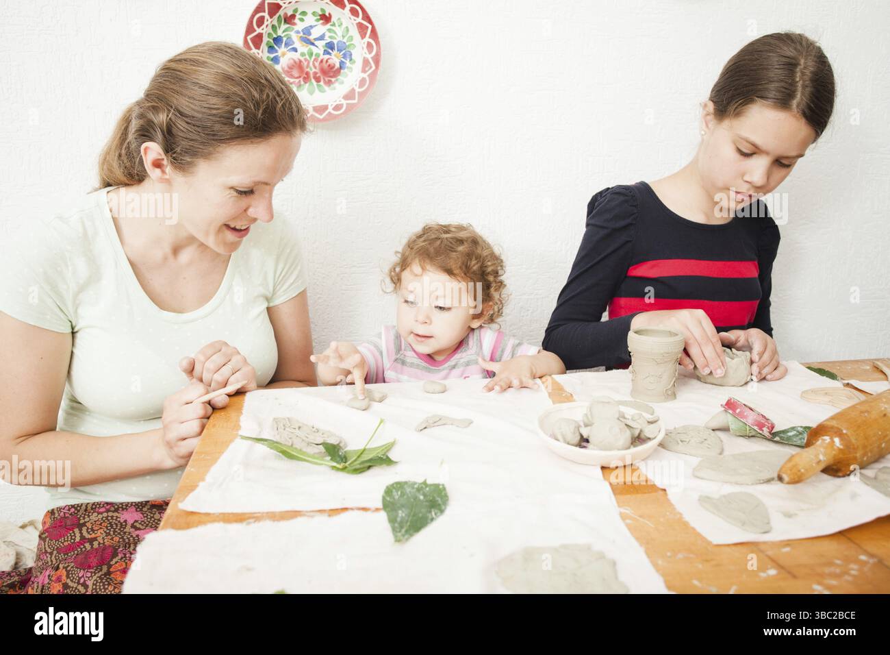 Process modeling figures from white clay, girls are making arts at the ...