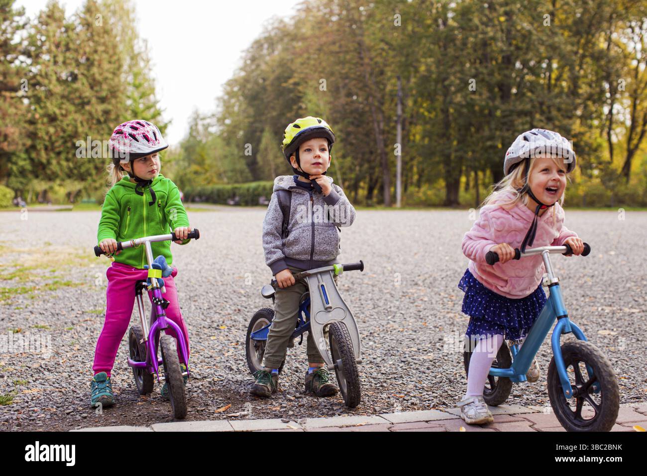 Group of cute preschool kids on balance bikes before their first cycling competition. Active and ...
