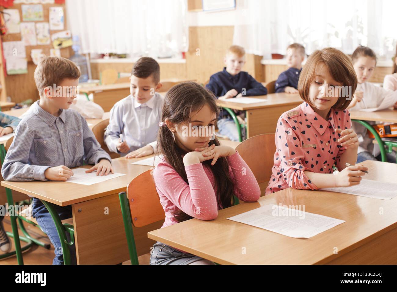 Children of primary school taking an exam writing school test Stock ...