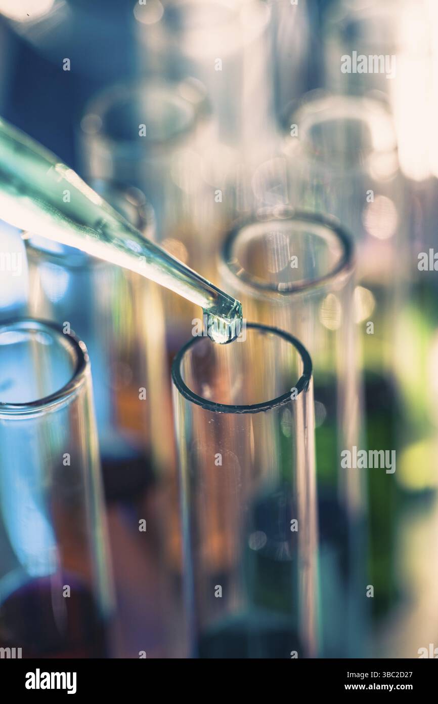 The blue drop from pipette over laboratory tubes Stock Photo - Alamy