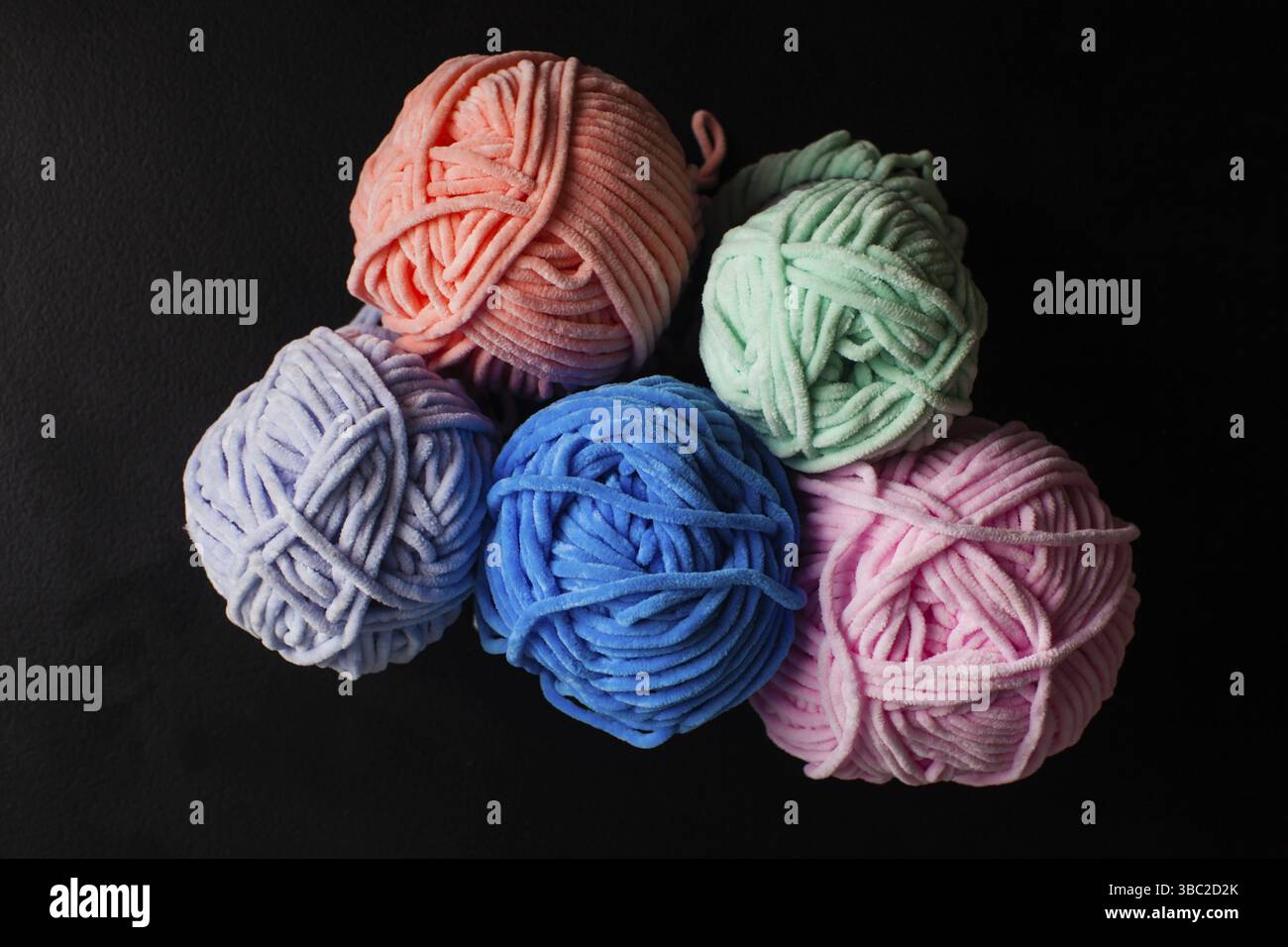 Plush yarn balls top view on the black background, top view Stock Photo ...