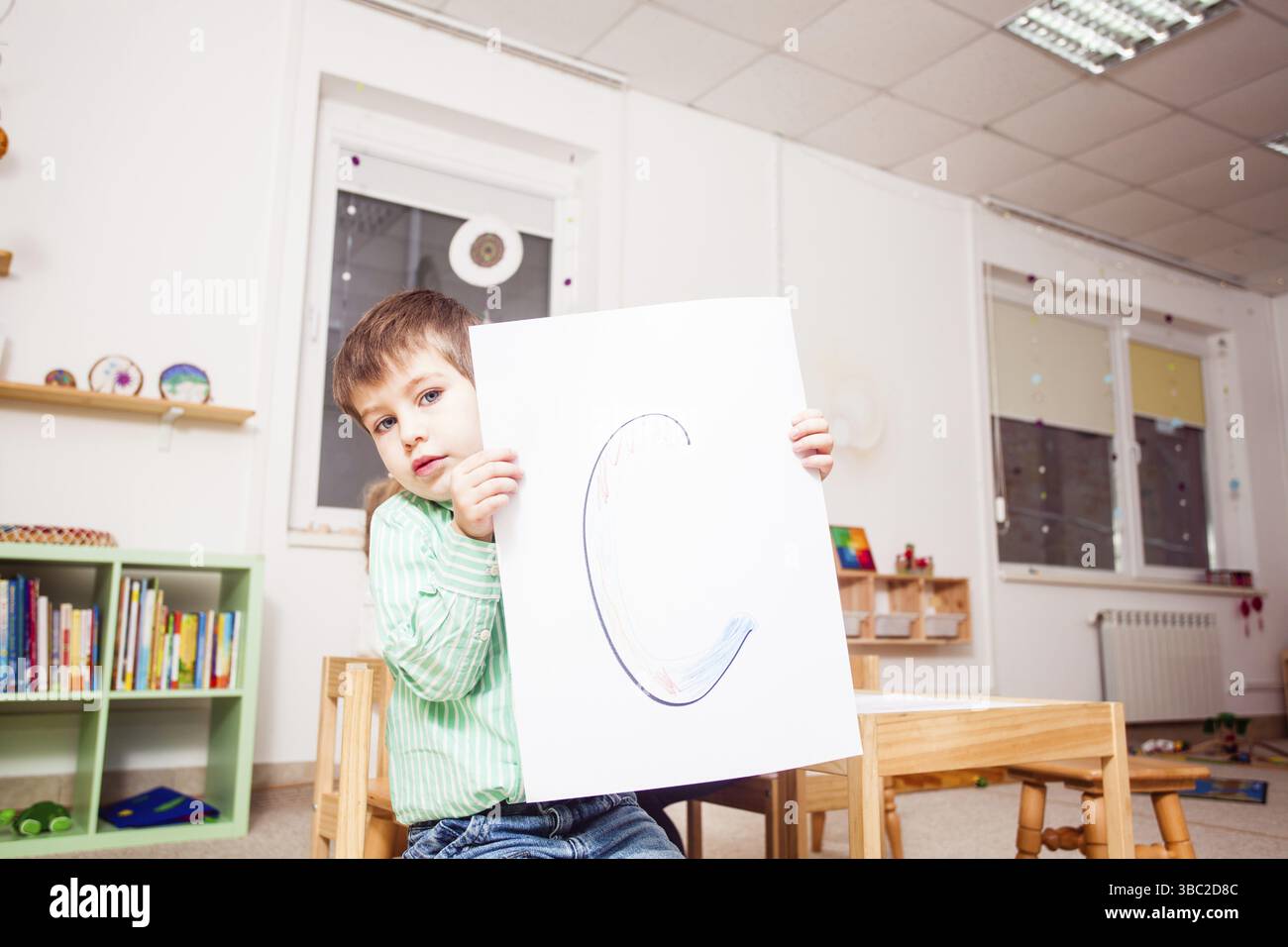 Overhead view of children in kindergarten learn letters and shapes ...
