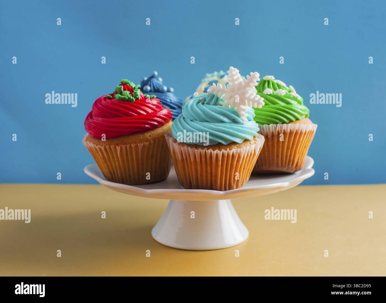 Christmas and winter cupcakes on the cakestand and gold background ...