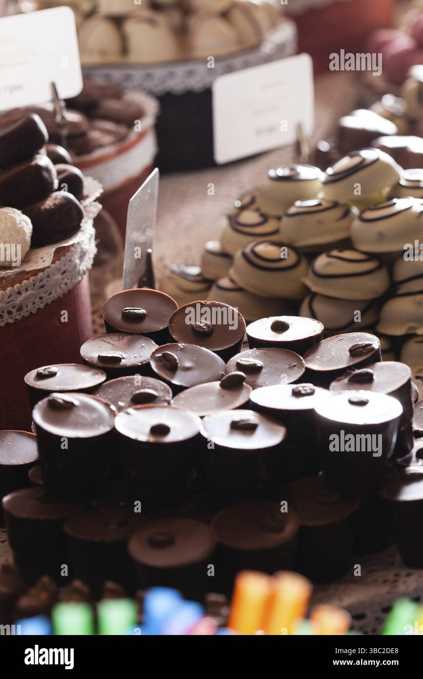 The sweets of different shapes and flavors set on a stand Stock Photo ...
