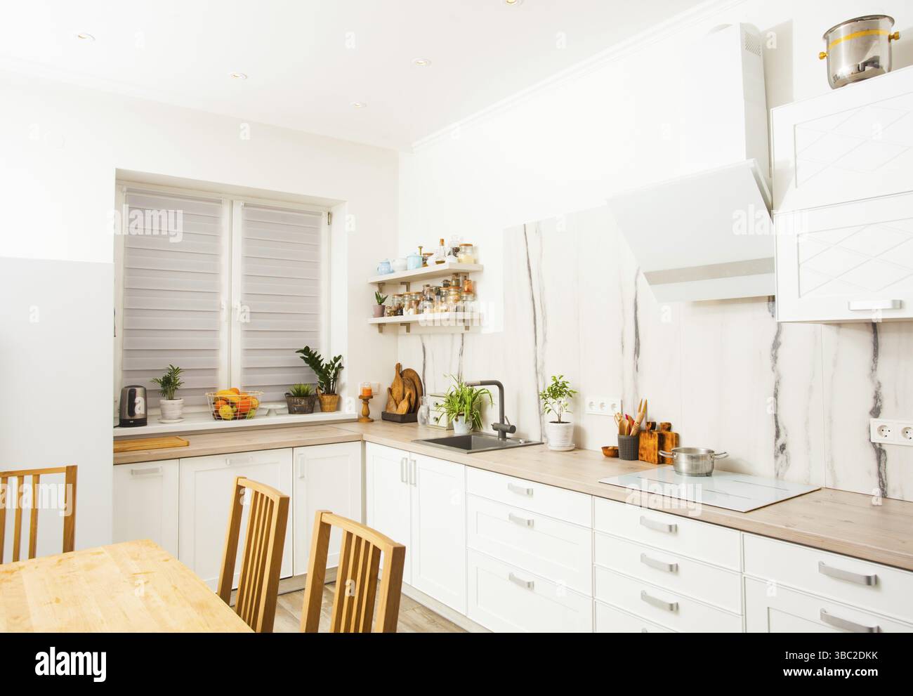 Modern scandinavian kitchen with open shelves with spices and cereals ...