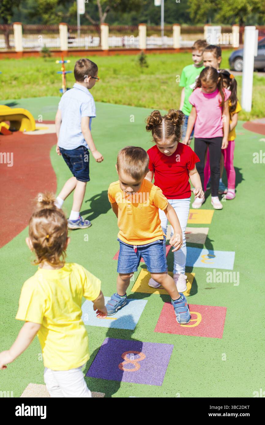 The kids jumping one by one playing hopscotch on a new playground Stock ...