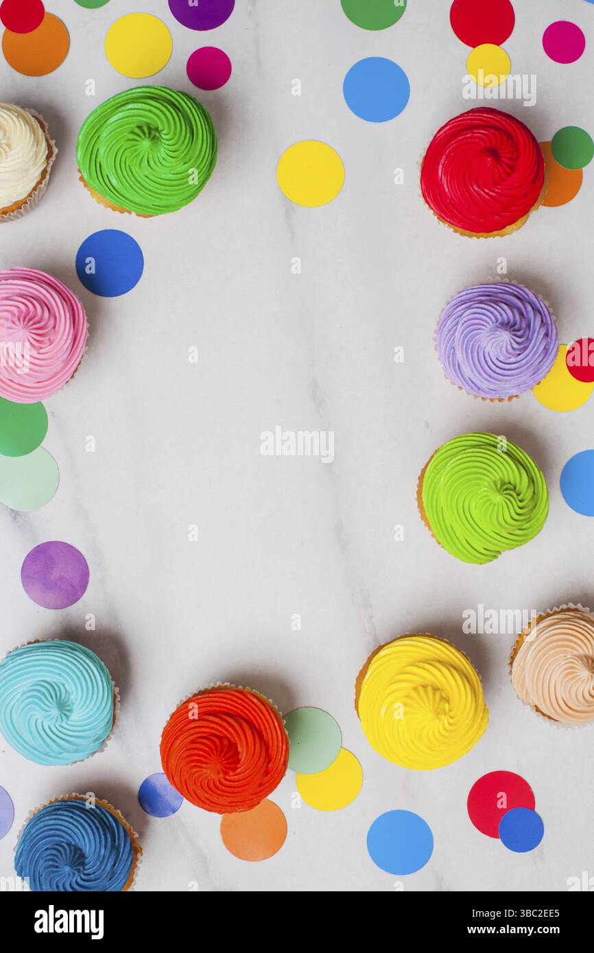 Colourfull cupcakes flat lay on the marble background with copy space ...